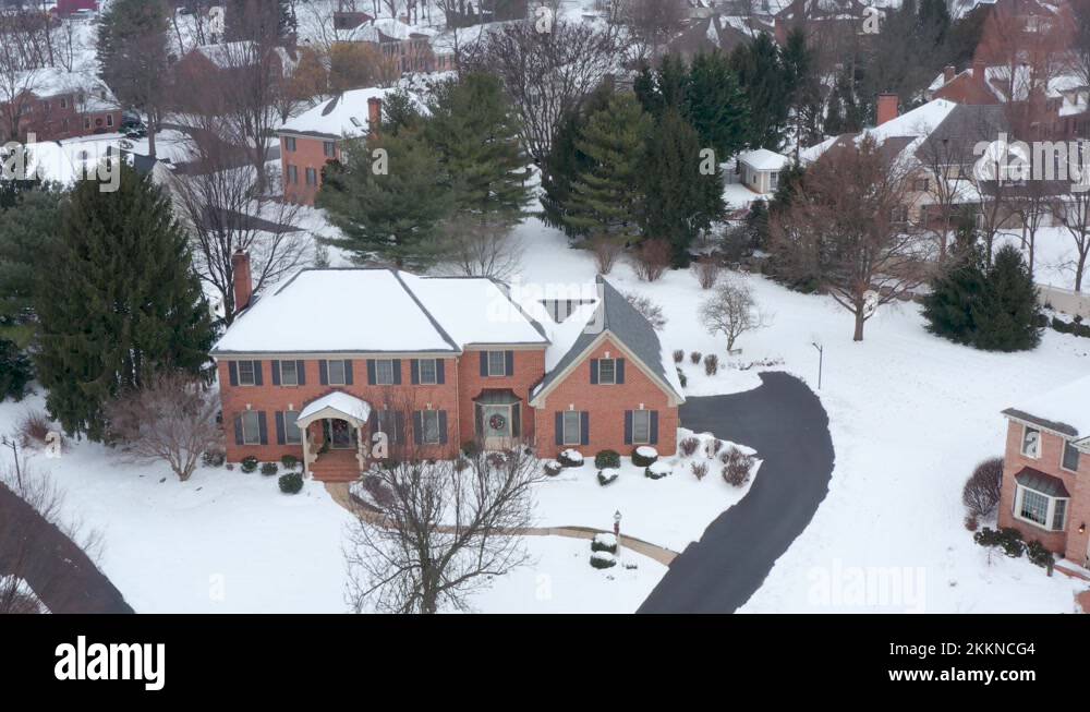 Large brick mansion covered in winter snow and decorated for Christmas ...