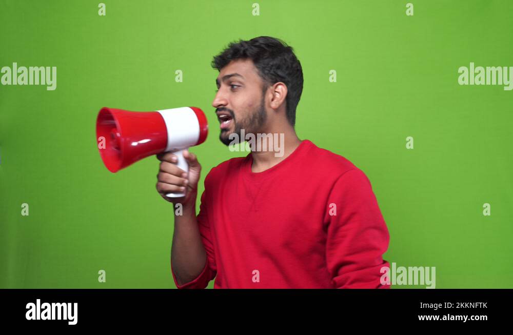 Man indian shouting through a megaphone on green screen chroma key ...