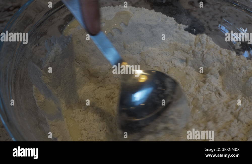 Spoon Mixing Egg, Flour, Yeast And Sugar In Mixing Bowl. Close Up, Locked Stock Video Footage ...
