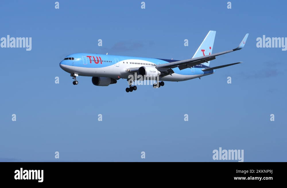 Descending Boeing 767 TUI Airlines. Airplane flying through blue sky ...