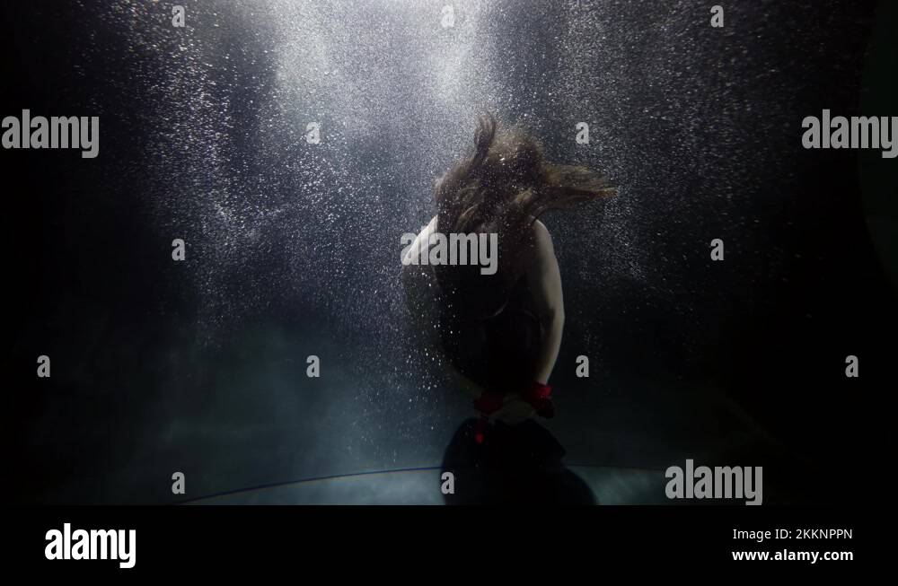 mystery underwater shot with floating female figure, slow motion in ...