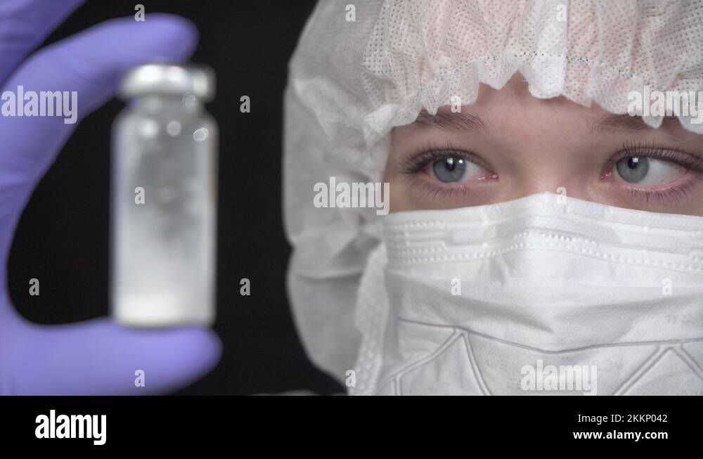 Close-up Female scientist doctor virologist in white hazmat protection ...