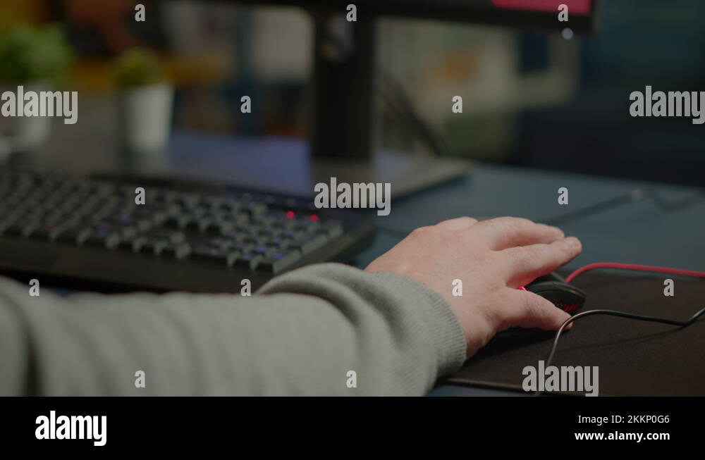 Close-up of man hands gamer playing video game using RGB keyboard Stock ...