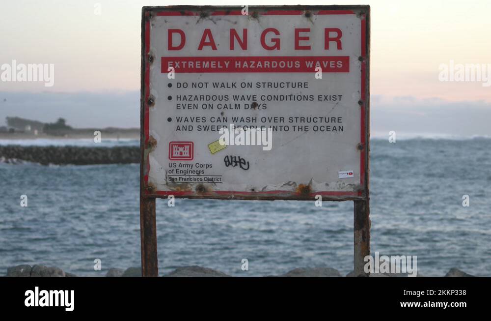 DANGER sign warns people of the extreme hazards of climbing on jetties ...