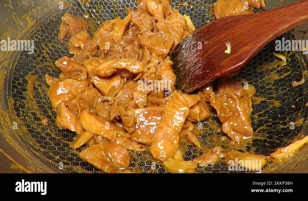 Pouring in vinegar on the stir fried pork meat Stock Video Footage - Alamy