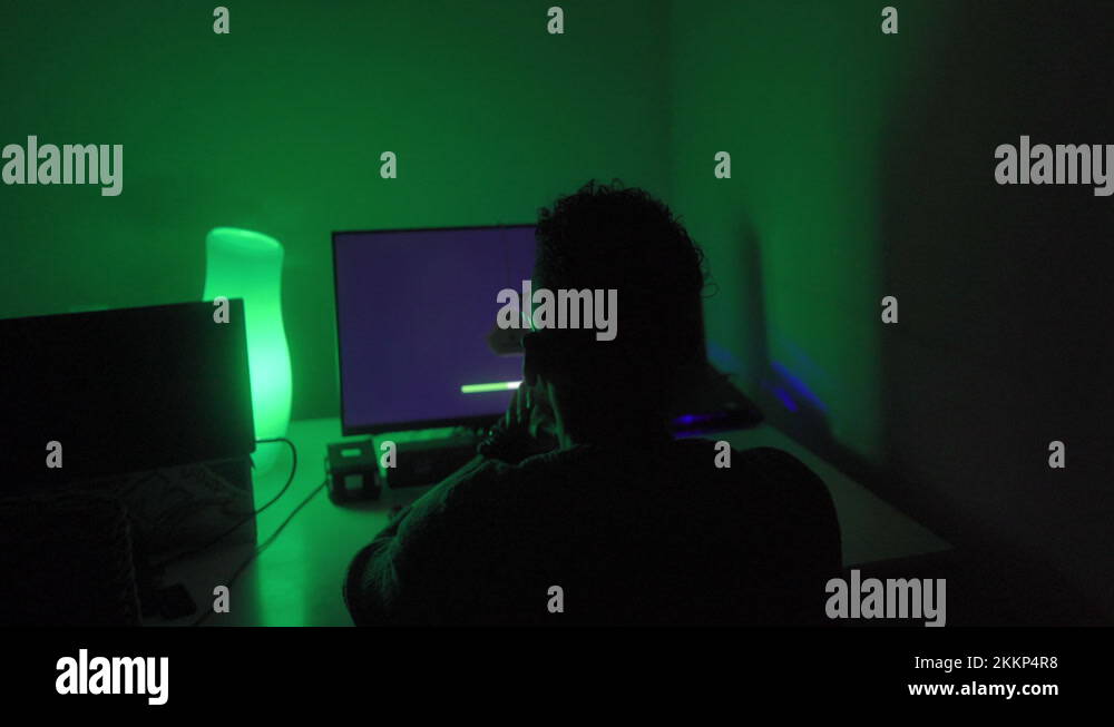 Man calibrating computer monitor in a dark room. Computer monitor color ...