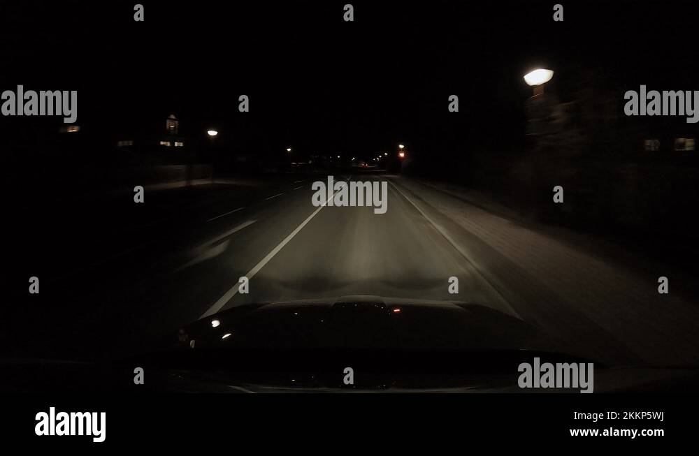 4k clip of a car with headlights on driving during night on a highway ...