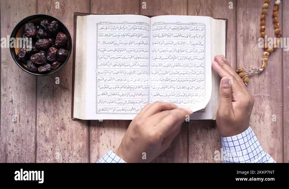 Muslim man hand turning pages of holly book of quran top view Stock ...