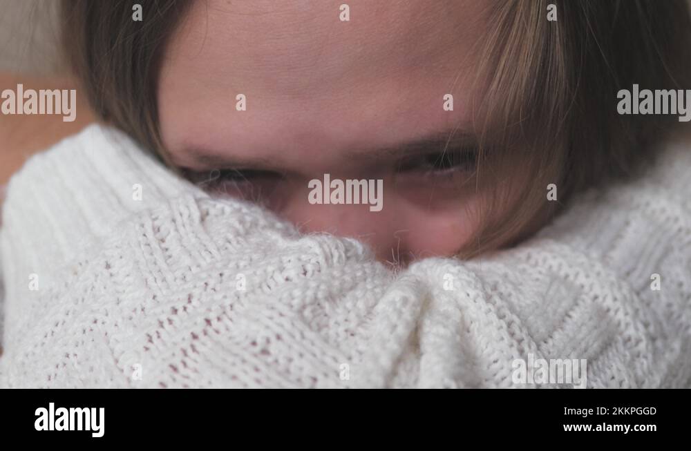 A teenage child cries and tears run down her cheeks. The girl is upset ...