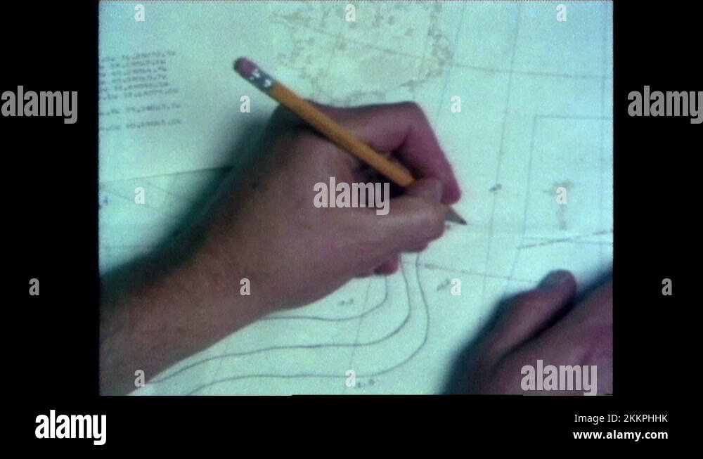 1980s: Person marks on geographical map. People in control room look at ...