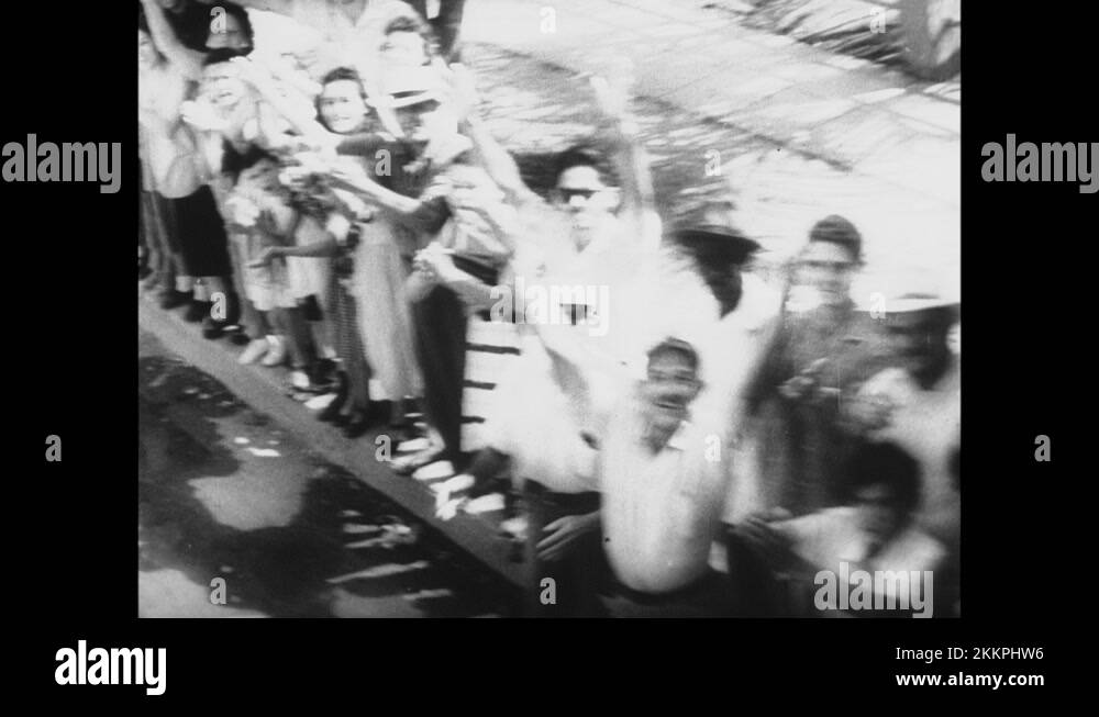 1960s Cuba: Fidel Castro and soldiers ride on tank. Crowd of people ...
