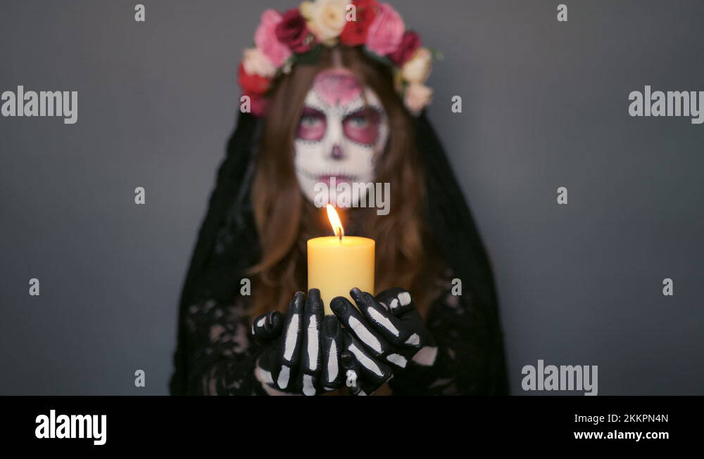 woman in the image of death Santa Muerte or sugar Mexican skull with a ...