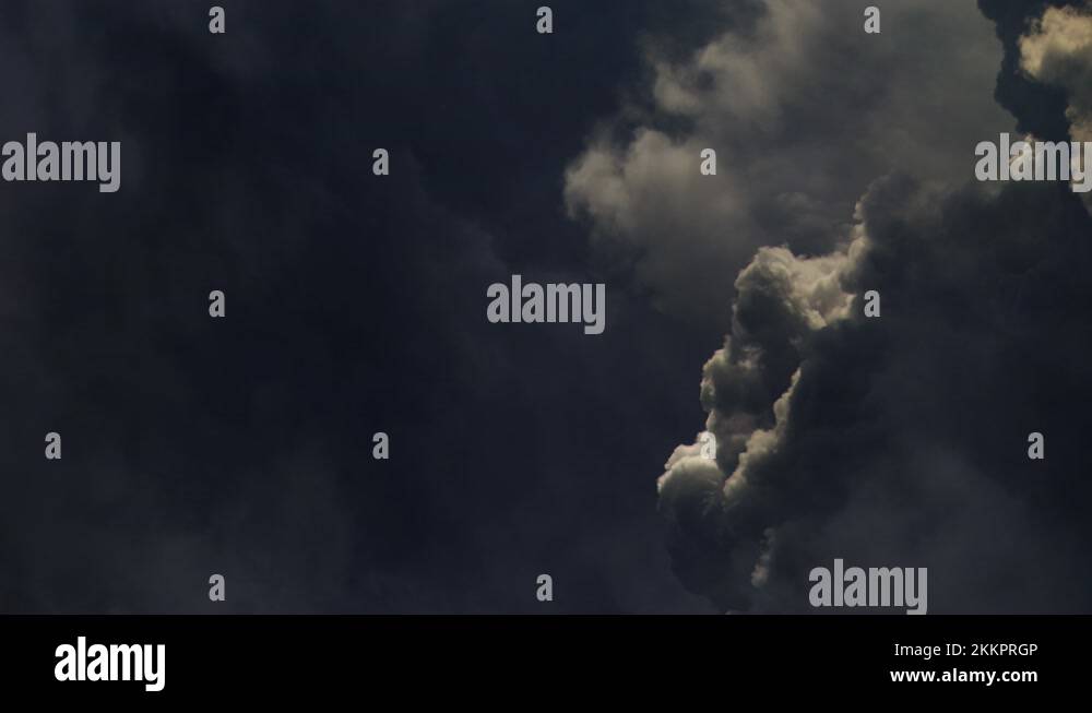 a thunderstorm in a dark cumulonimbus cloud with a flash of lightning ...