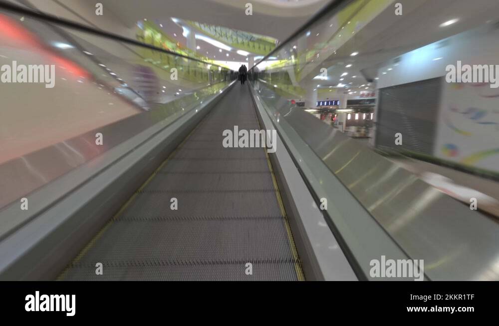 Walk through a large shopping mall travel on escalators to different ...
