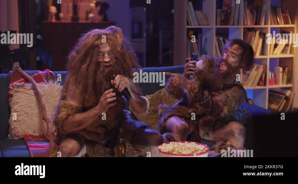 Funny Two Cavemen in Animal Fur Singing Songs having Fun Shaking Heads ...