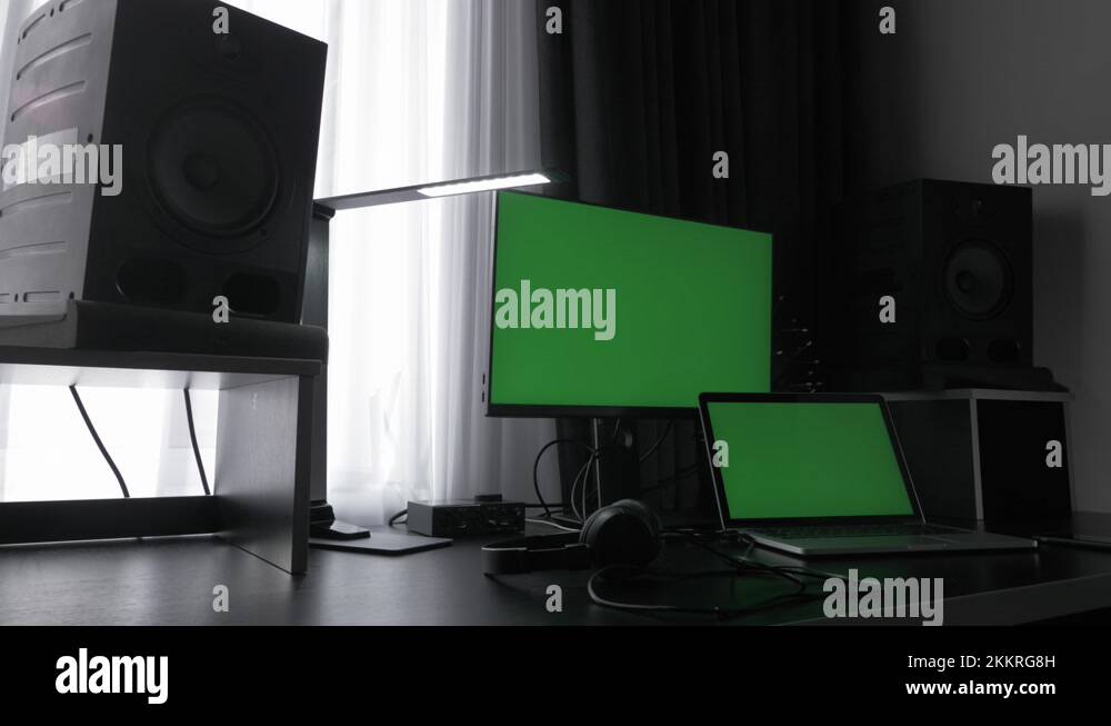 Modern workplace with laptop computer, green screens and studio ...