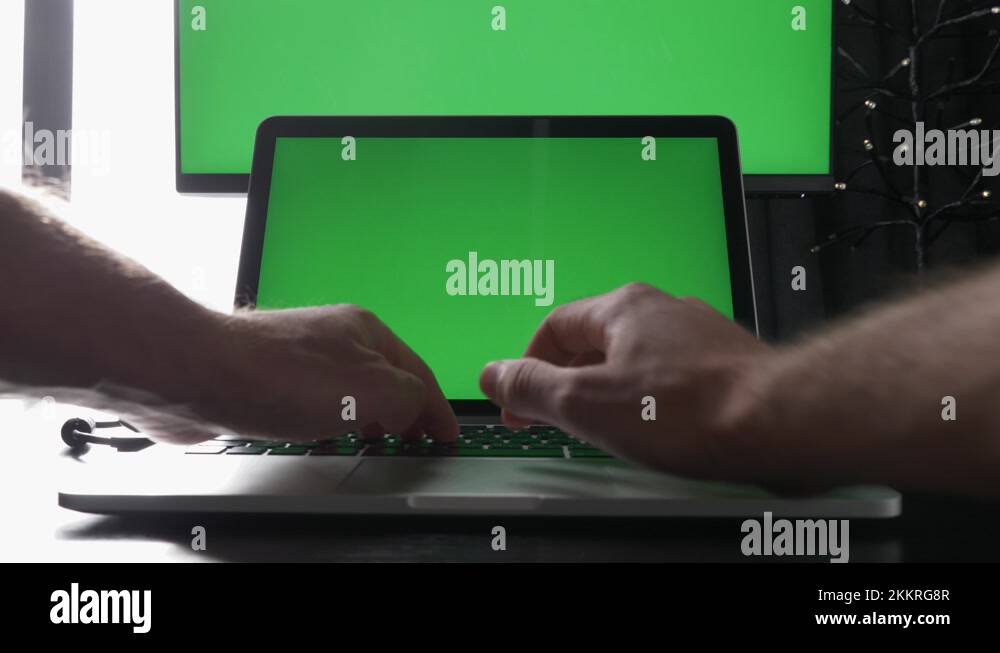 Man using green screen mockup on laptop computer in office. Chroma key ...