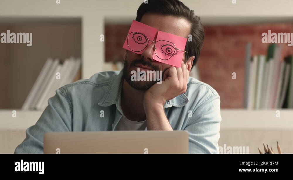 Employee covering eyes with sticky notes sleeps at workplace Stock ...
