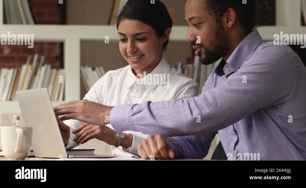 Indian and African colleagues talking preparing online project on ...