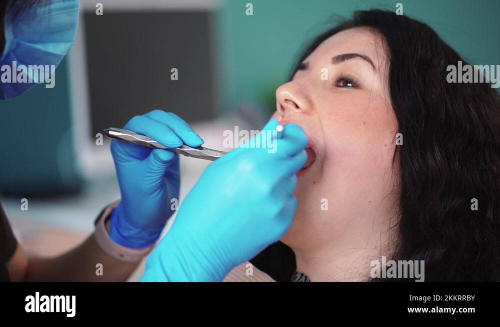 Woman Dentist with Assistant Does Brushing Teeth Female Patient in ...
