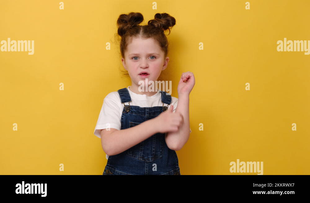 Unhappy little girl scratching an itch with hand, suffers from allergy ...