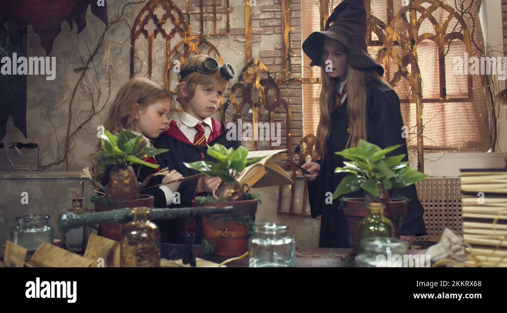 Two little children are reading a book in class of a magic school ...