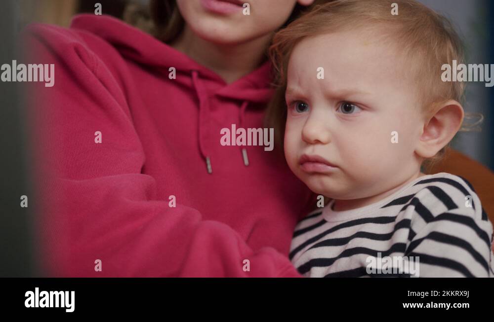 Happy young mother and little son are watching cartoons, being lockdown. Mom and Stock Video ...