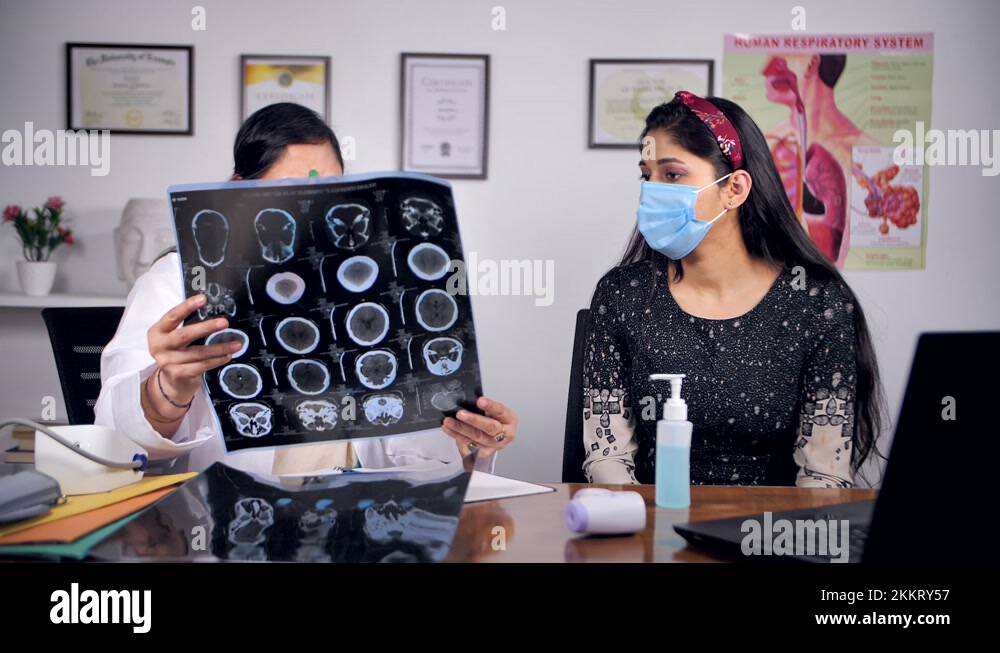 Indian doctor showing a CT scan / X-ray to a patient - COVID-19 ...