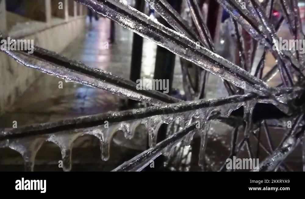 Bicycle covered in ice after frozen rain phenomenon. City in winter ...