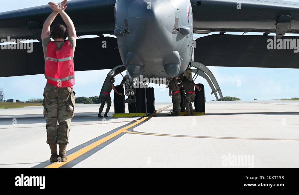 USAF ground crew placing chocks at landing gear of B-52 Stratofortress ...