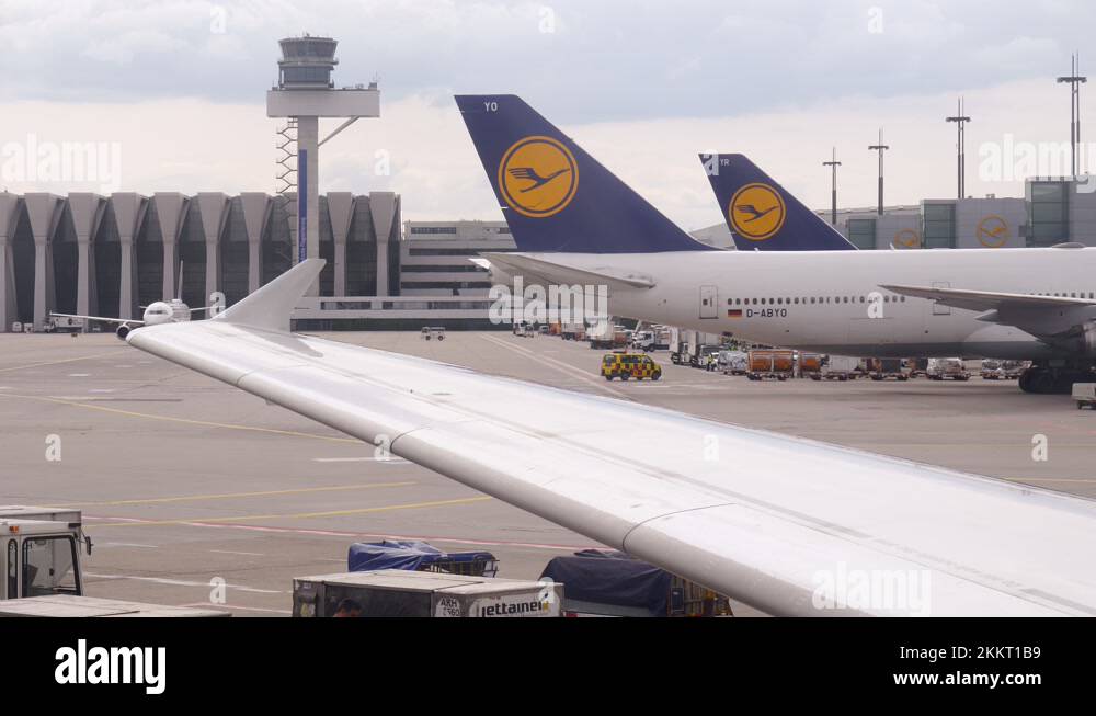 Large Jumbo Jet moved backwards from terminal gate by tug, view through ...