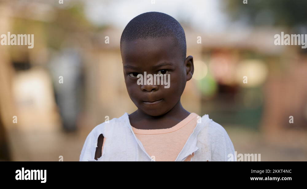 Poverty.Inequality.Portrait of a poor Black African boy looking at ...