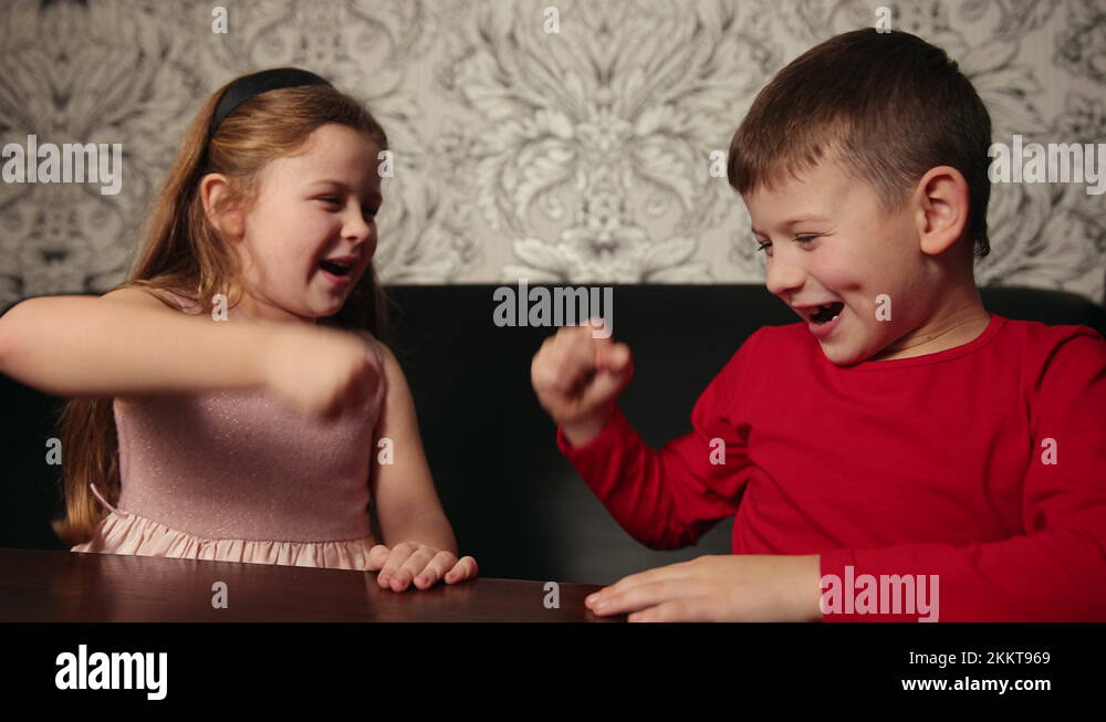 Little boy and girl play rock paper scissors. Happy children, kids ...