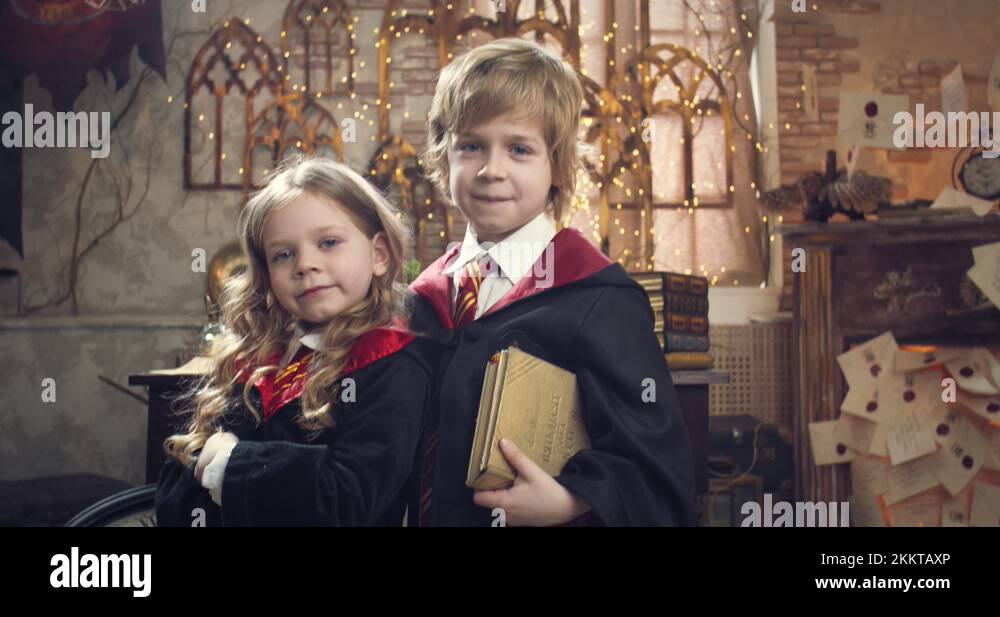 Bright and colorful class in the wizard school with two little students ...