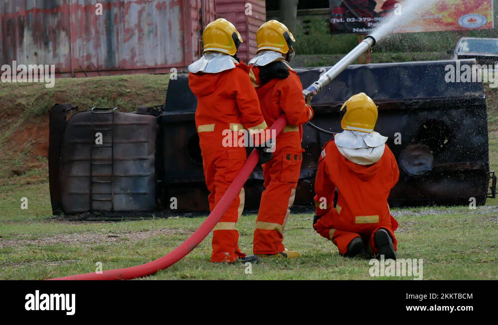 Firefighter fighting with fire flame protection property. Fireman wear ...