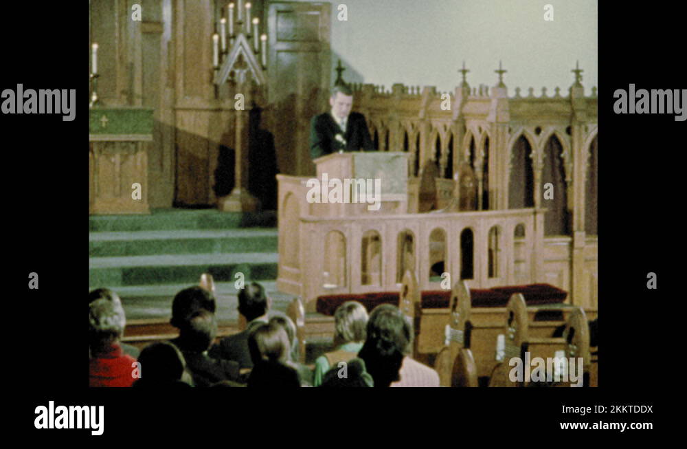1970s: Pastor gives sermon in front of church. People in pews, pastor ...