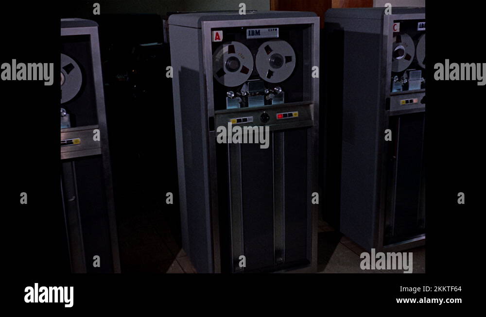 1960s: film slate clapper board. Man in uniform walks up to reel to ...