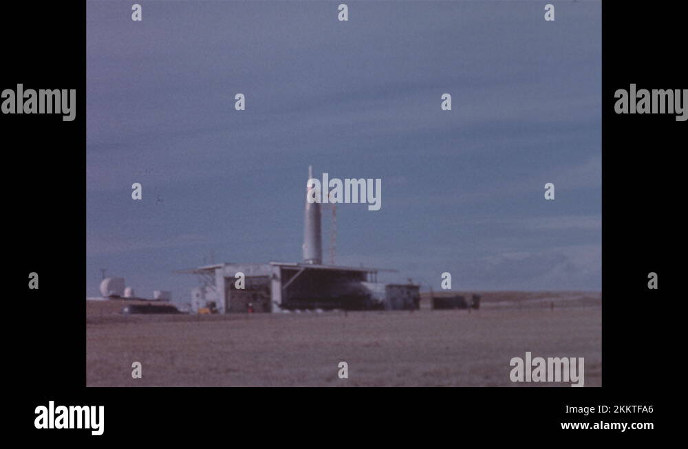 1960s: Military complex with ICBM missile raised vertically behind ...