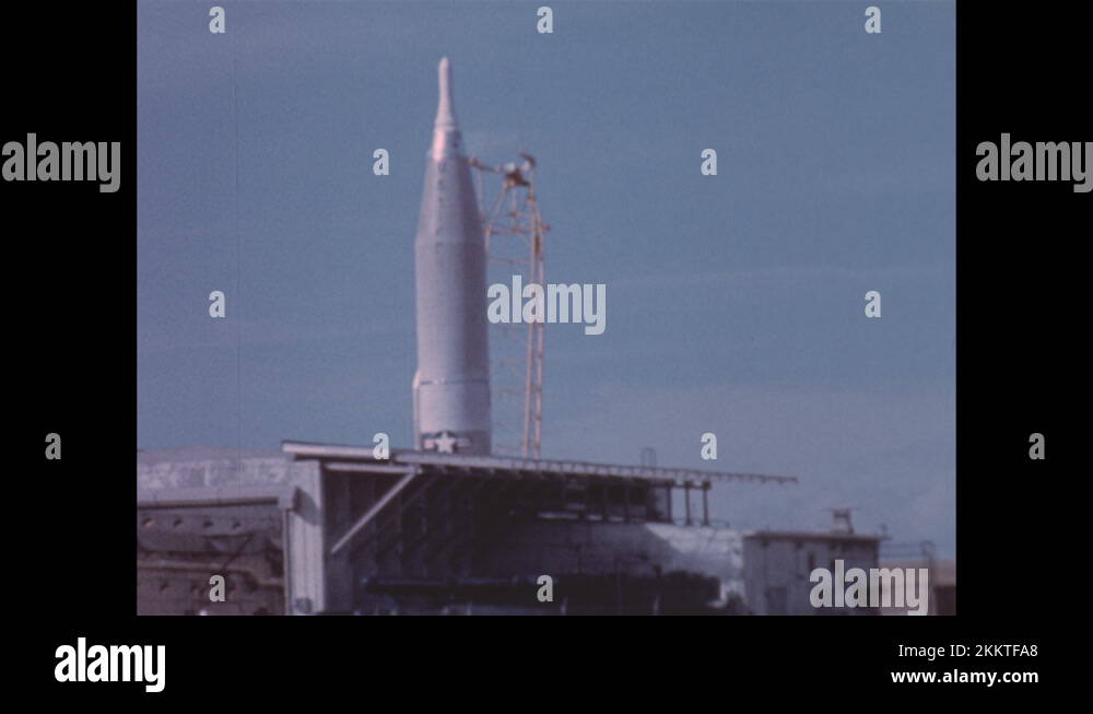 1960s: Military complex with ICBM missile raised vertically behind ...