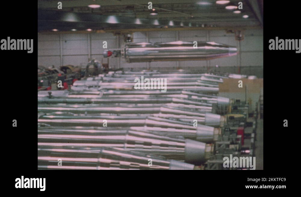 1960s: ICBM Missile body is lifted and moved above a long row of other ...