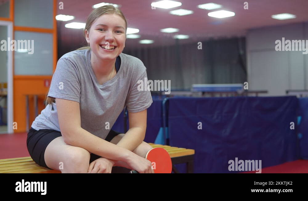 Portrait of a smiling teen girl table tennis player with a ping pong ...