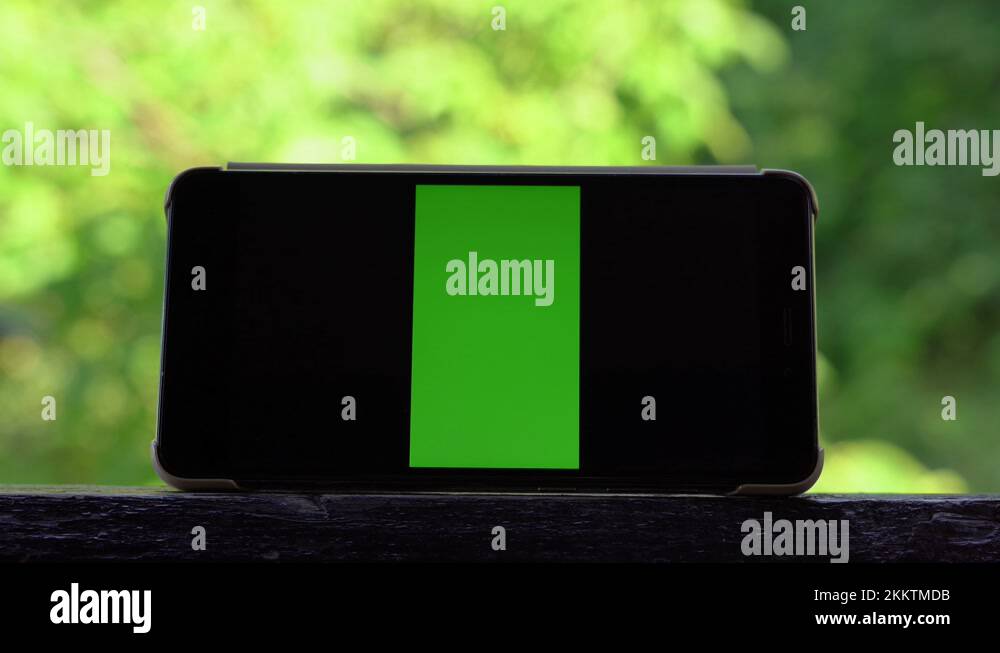 Woman makes pinch gesture to zoom green page on screen of phone Stock ...