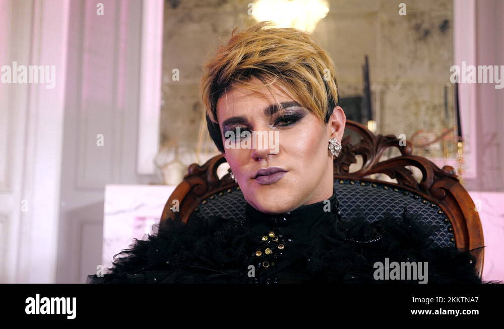 Portrait gay man transgender sit chair lgbt makeup. Trans look camera ...