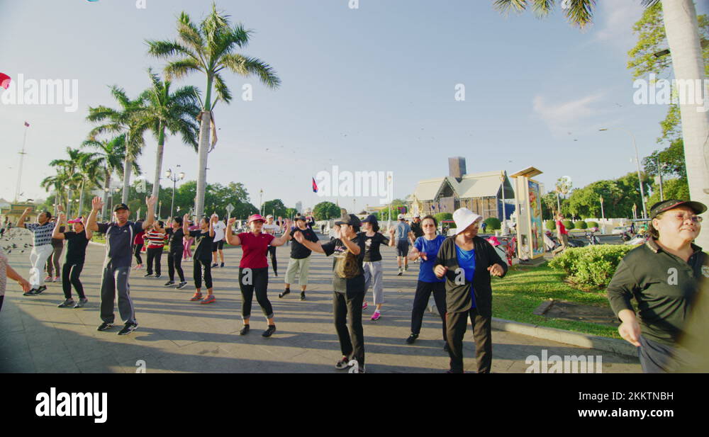 Women Line Dancing Along The Tonle Sap River In Phnom Penh, Cambodia ...