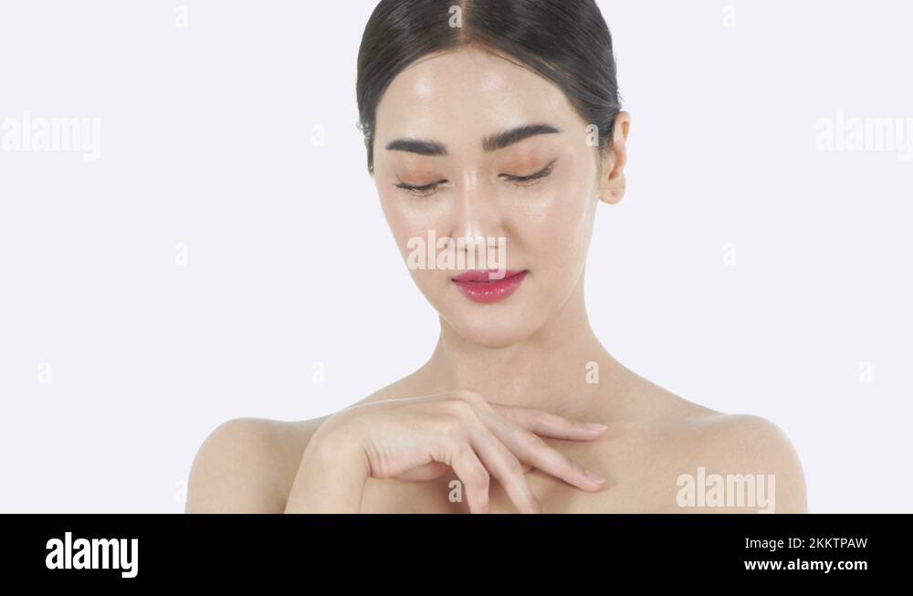 Beauty concept of 4k Resolution. A young Asian woman caresses her skin ...