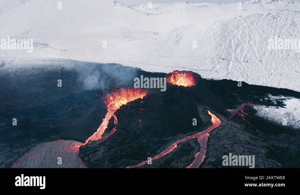 Volcano spewing glowing magma from basalt cone in Iceland ...