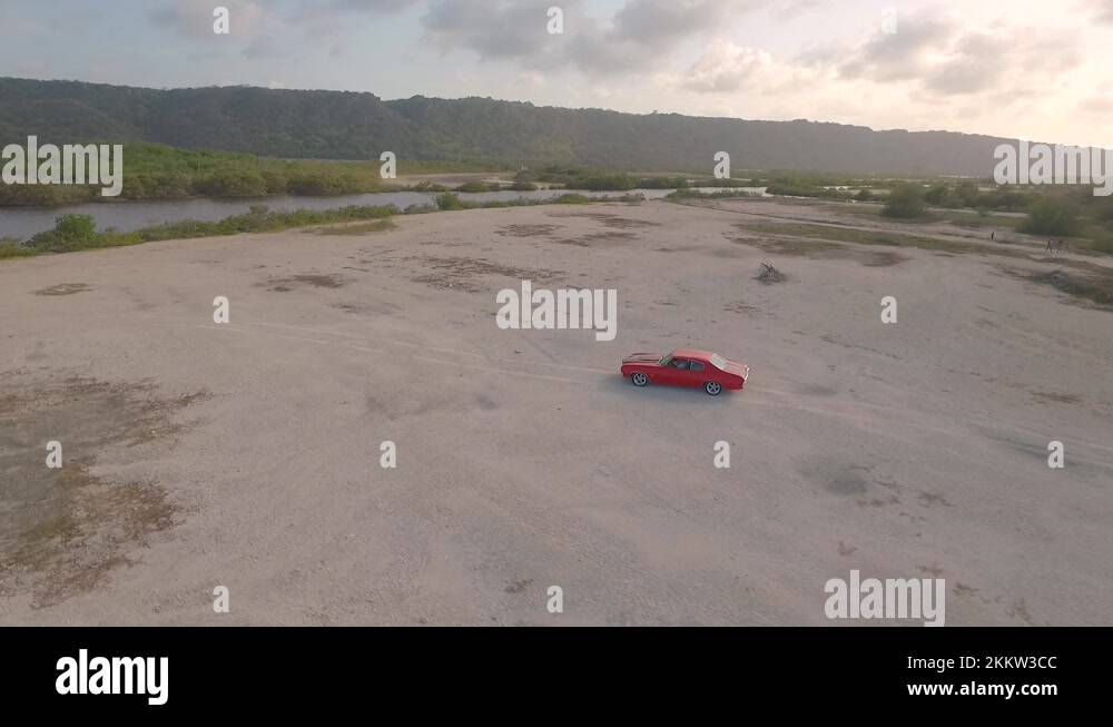 From the top view of an old American muscle car in a desert during ...