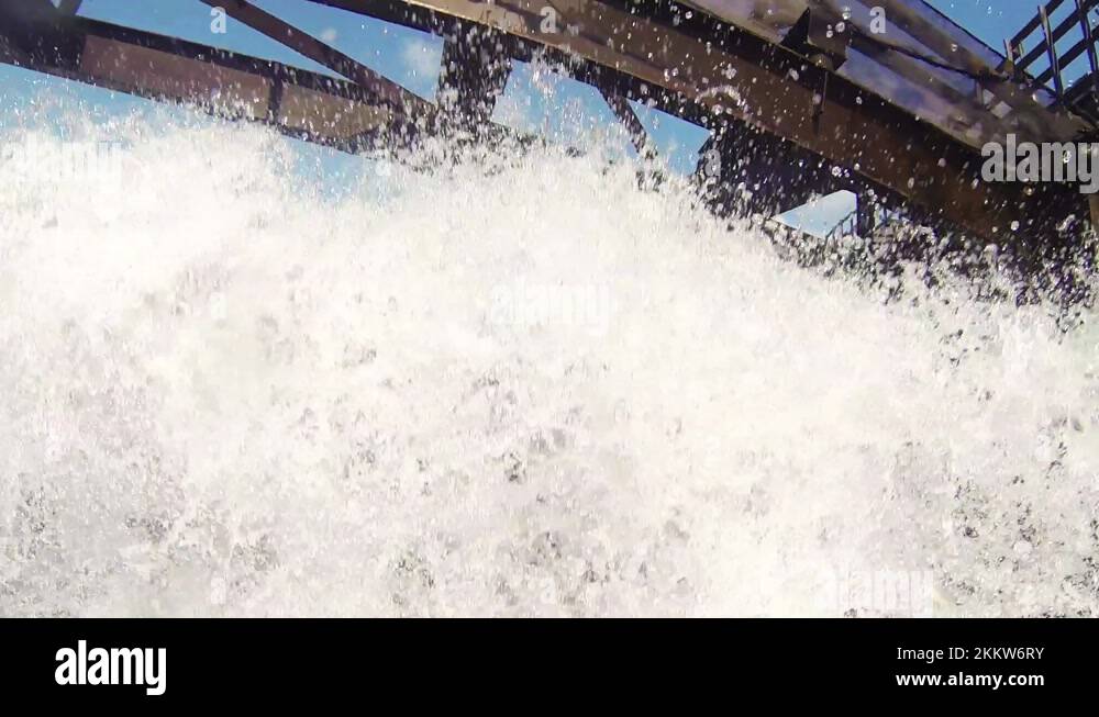 Crush down in water from water roller coaster in amusement park. Spray ...