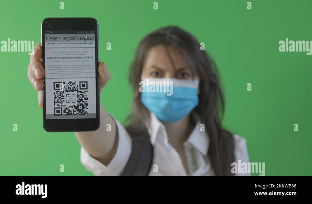 Woman with face mask shows smartphone to scan the digital health ...