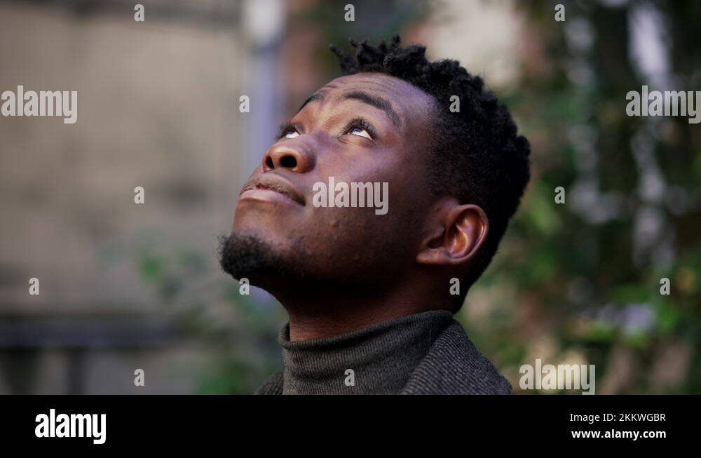 Young black African man looking up at the sky with HOPE and FAITH Stock Video Footage - Alamy